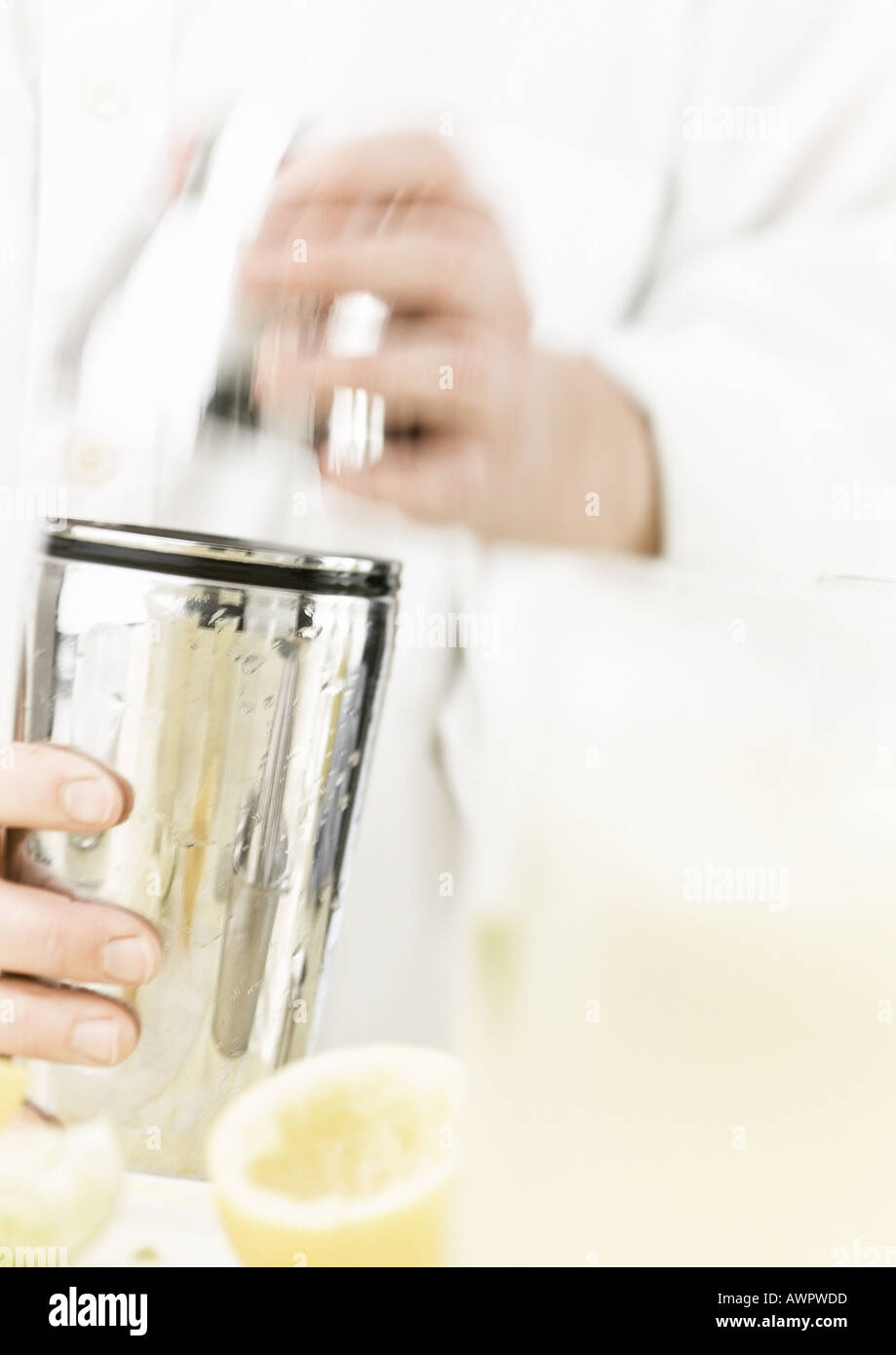 Person mixing cocktails, cropped view Stock Photo - Alamy