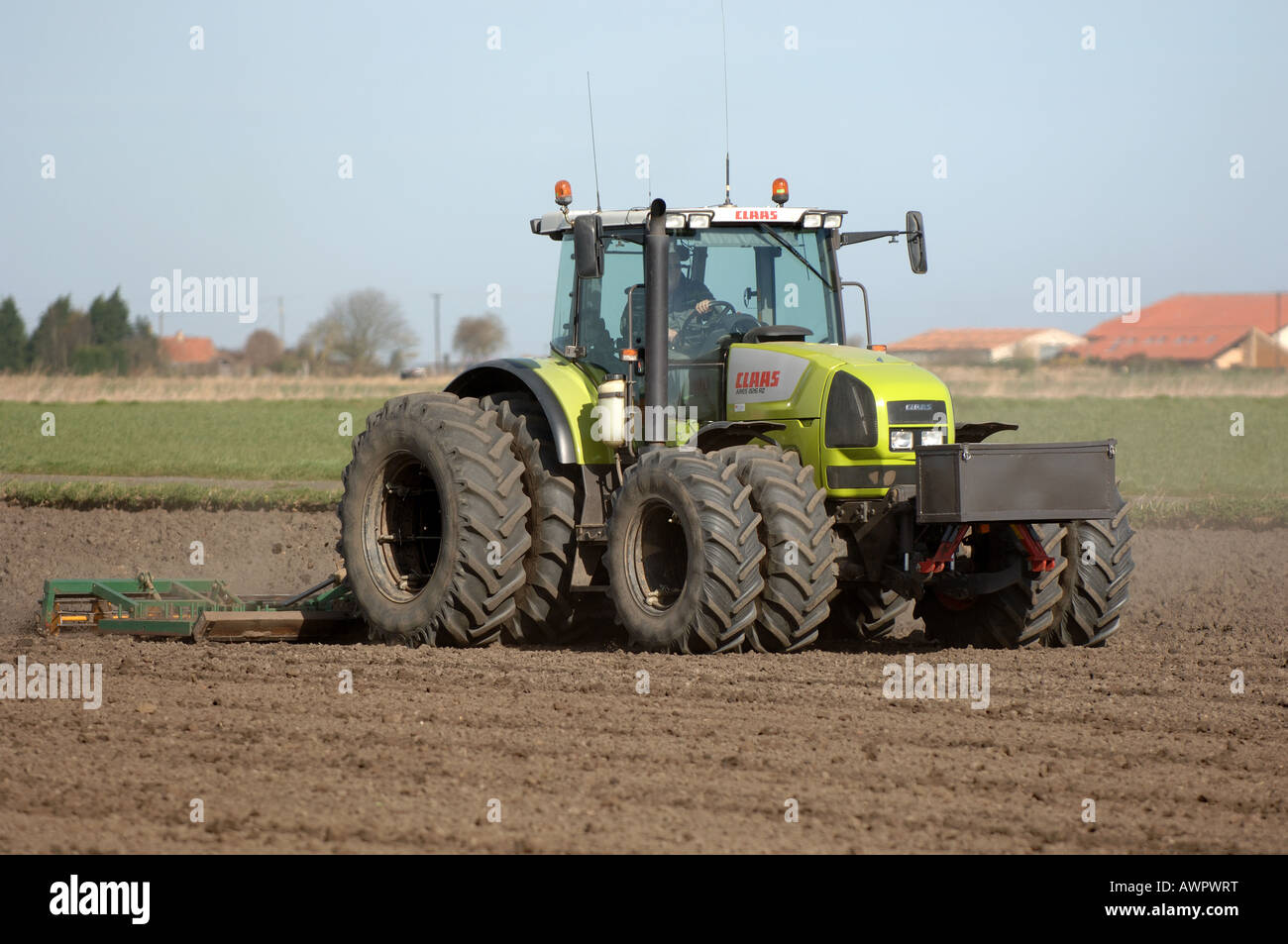 Claas Tractor preparing land for planting Stock Photo - Alamy