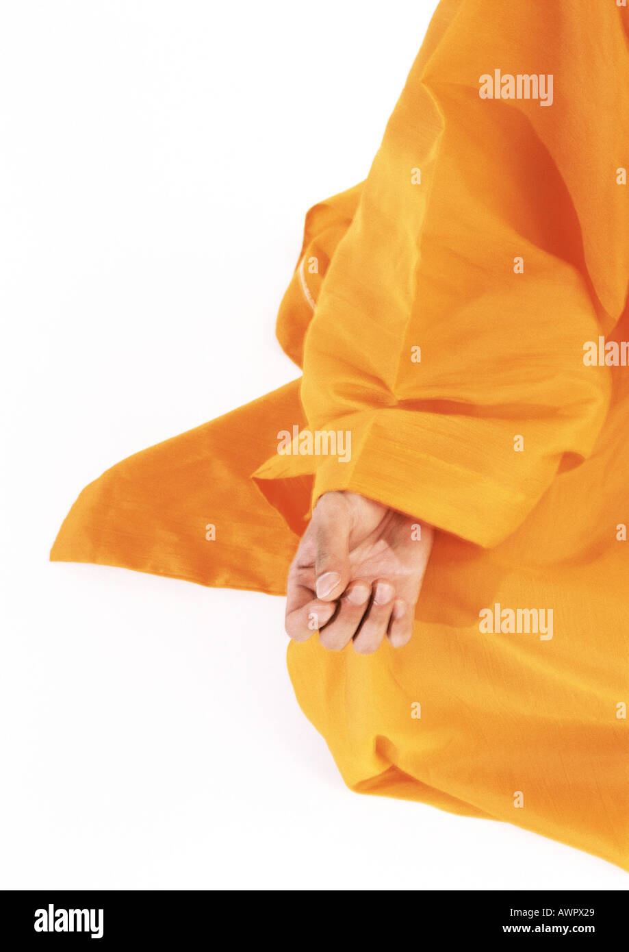 Buddhist monk's hand on knee in lotus position Stock Photo - Alamy