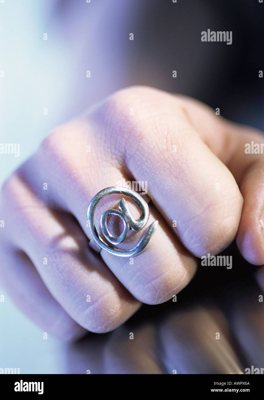 Hand wearing @ ring, close-up Stock Photo - Alamy