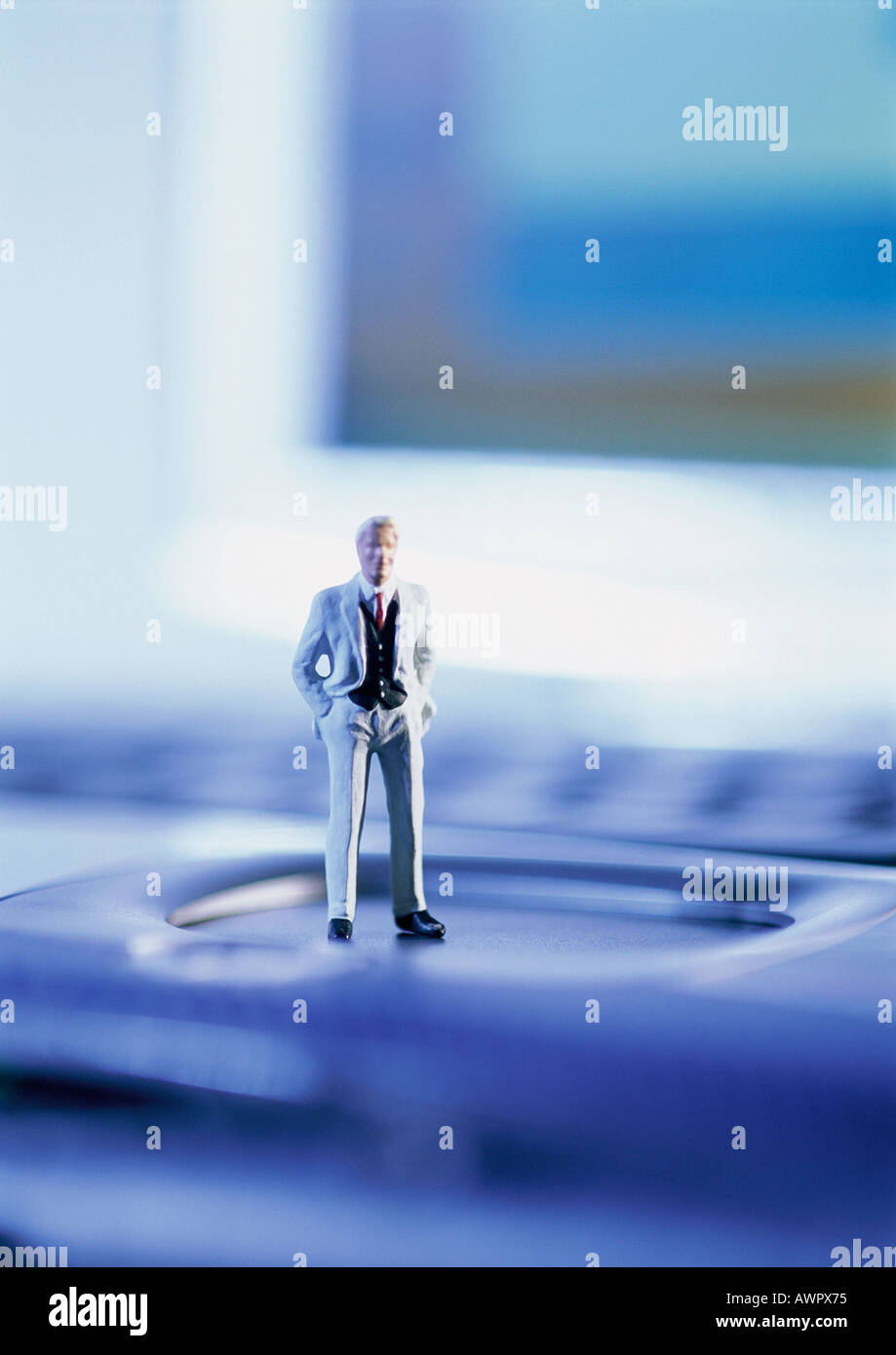 Small toy figure standing on computer keyboard, focus on figure Stock ...