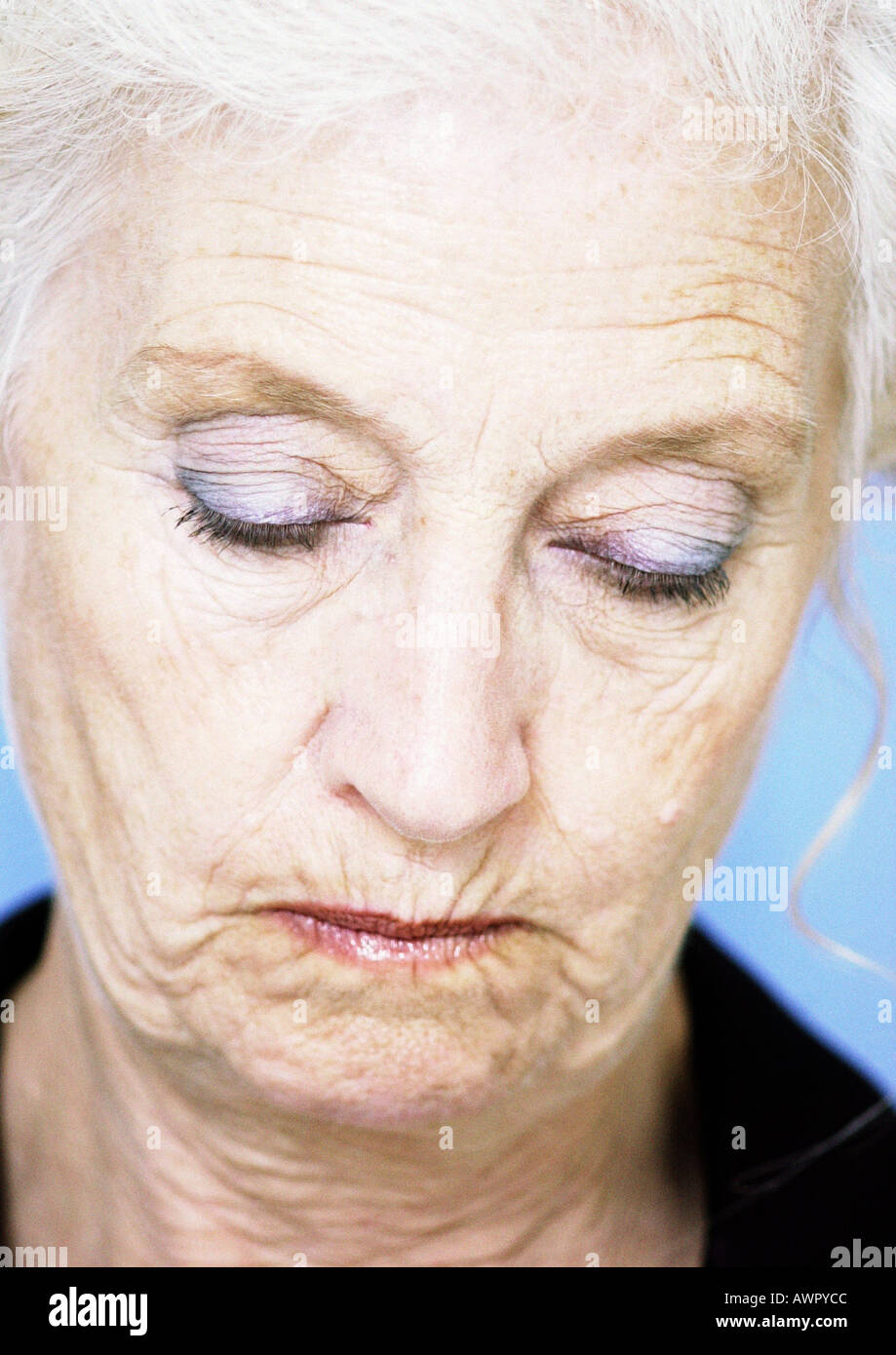 Senior woman looking down and pursing lips, portrait, close-up Stock ...
