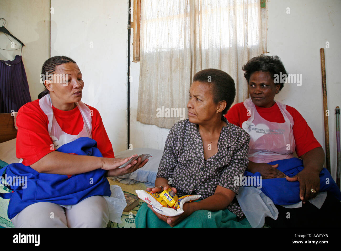 Namibia - AIDS charity, woman giving medicine to HIV+ woman Stock Photo ...