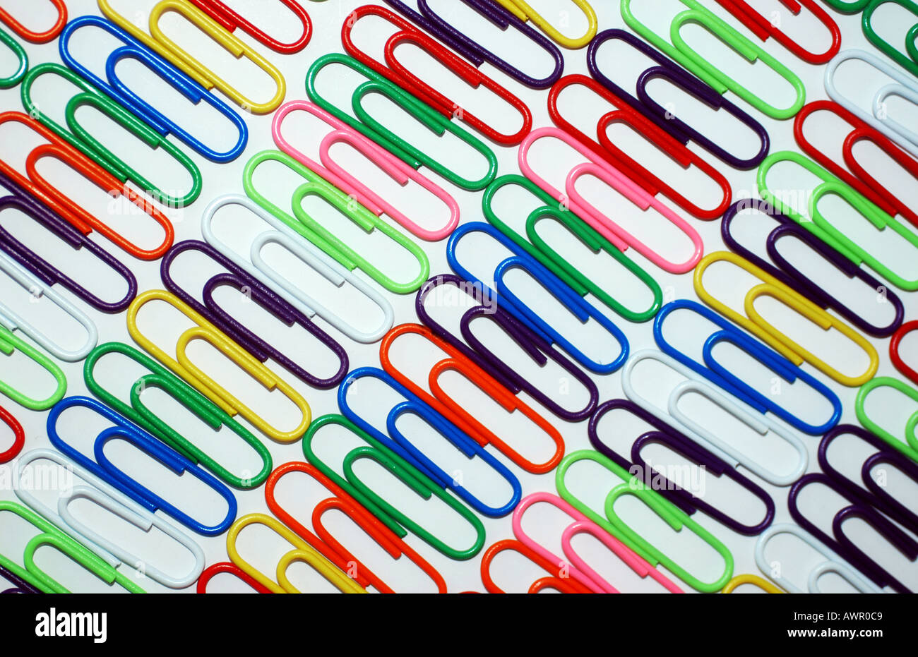 Coloured paper clips on a white background Stock Photo - Alamy