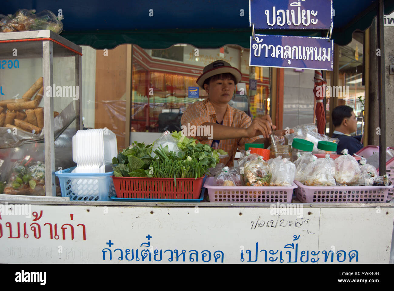 from her street stall, this female food vendor offers spring rolls, dim ...