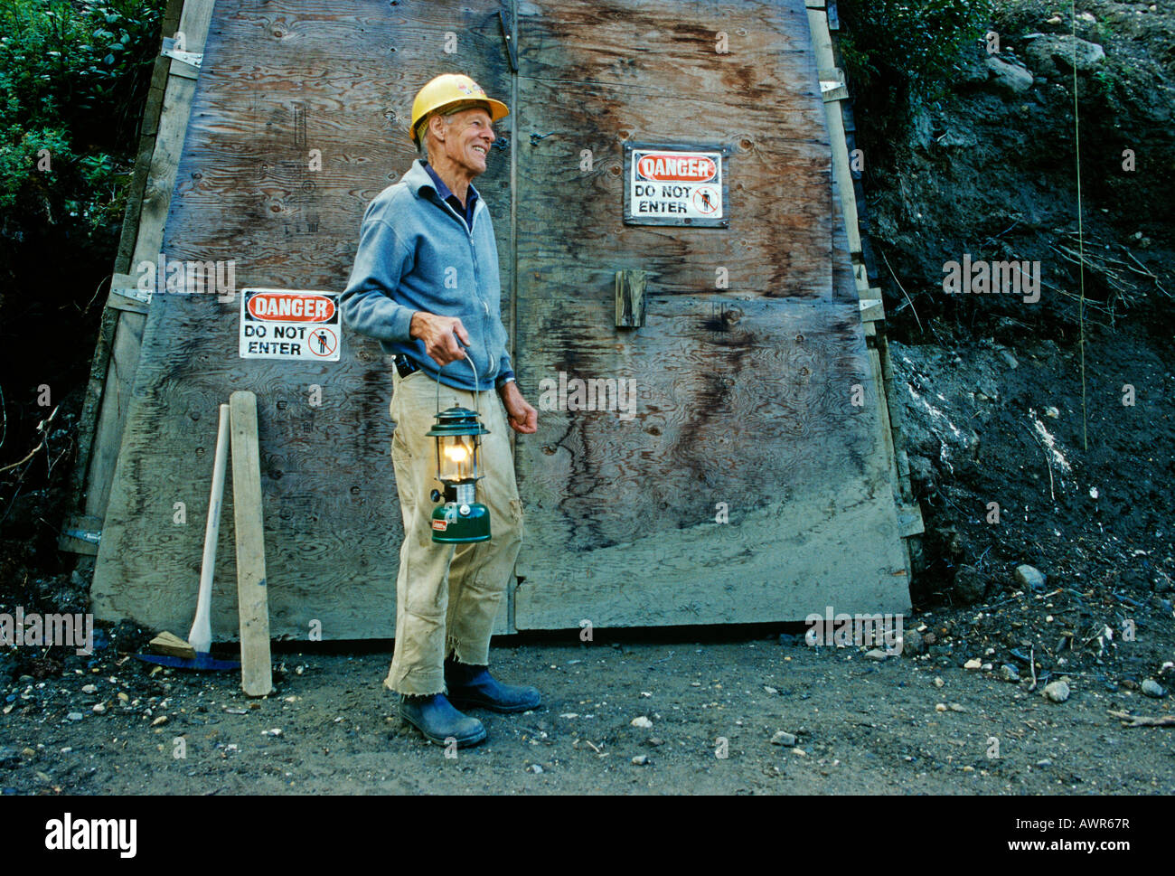 Prospector standing in front of the entrance to his mine, Brooks Range ...