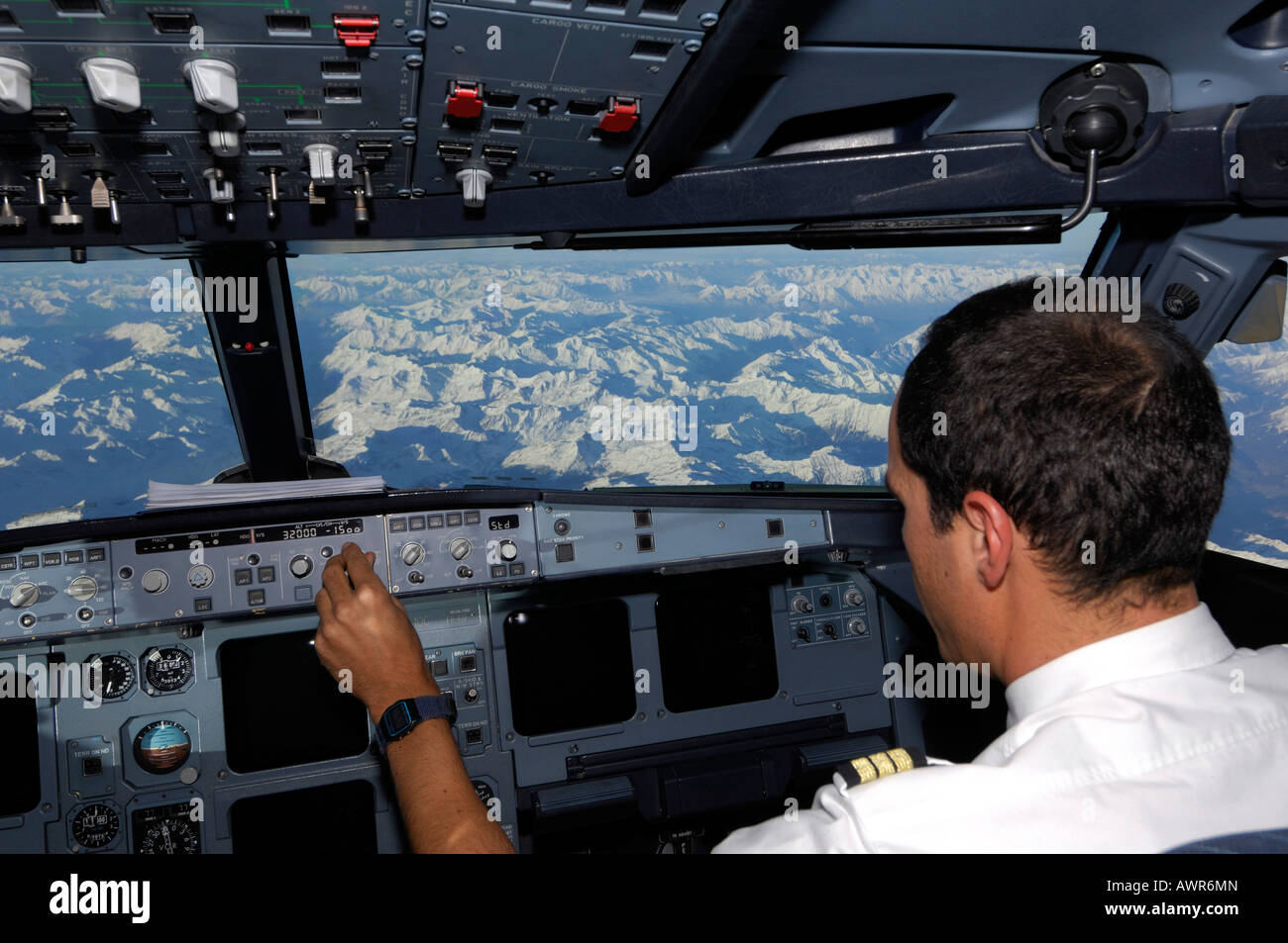 Pilot in the cockpit of an Airbus 321, in flight over the Alps Stock ...