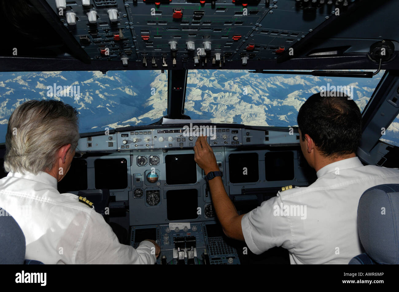 Pilots in the cockpit of an Airbus 321, in flight over the Alps Stock ...