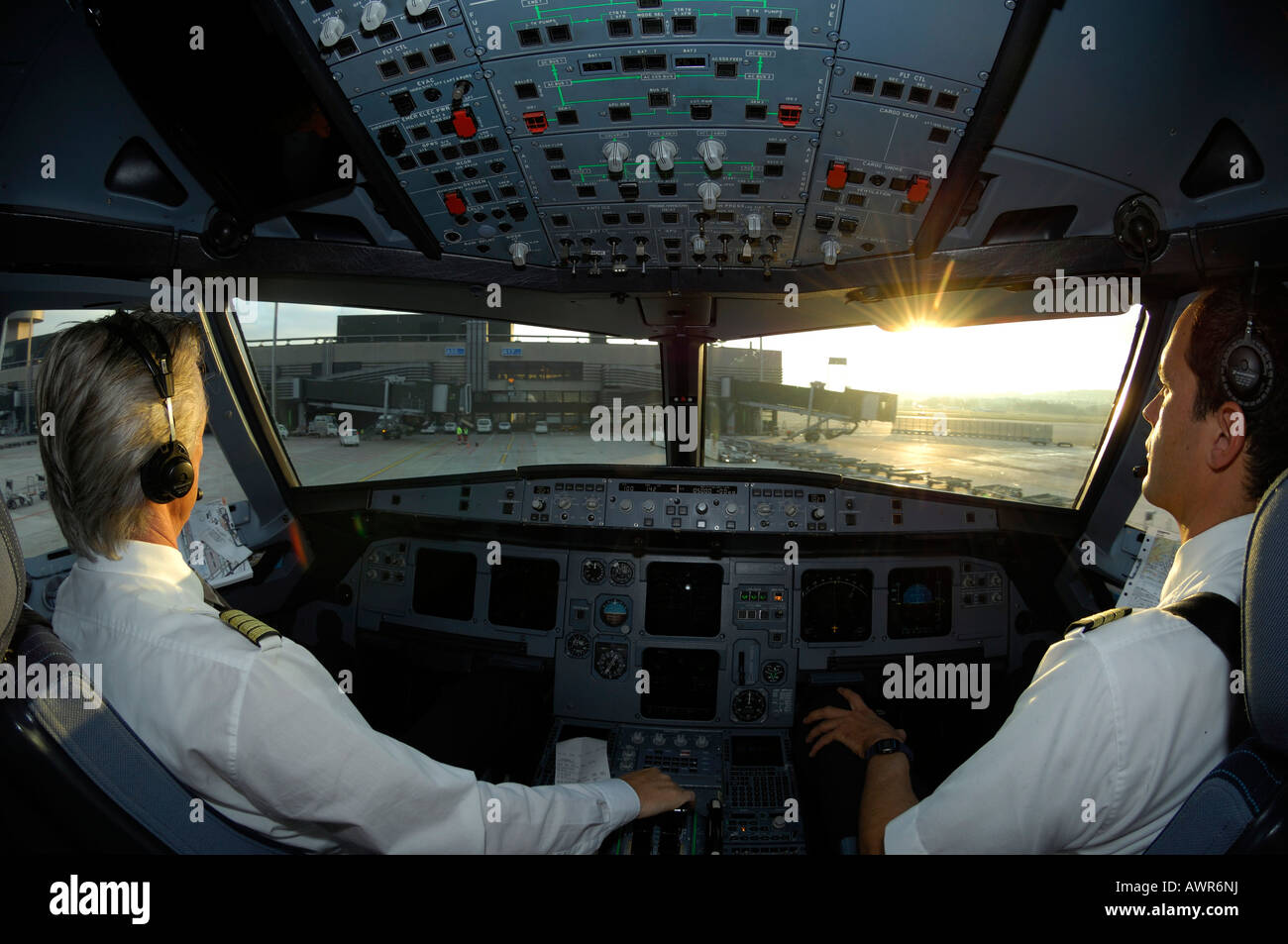 Pilots in the cockpit of an Airbus 321, taxiing to gate after landing ...