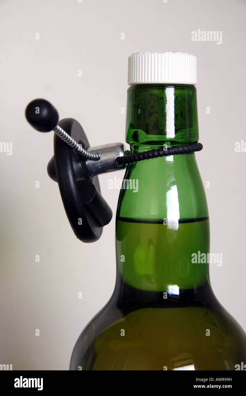 A security tag on a full whisky bottle Stock Photo - Alamy