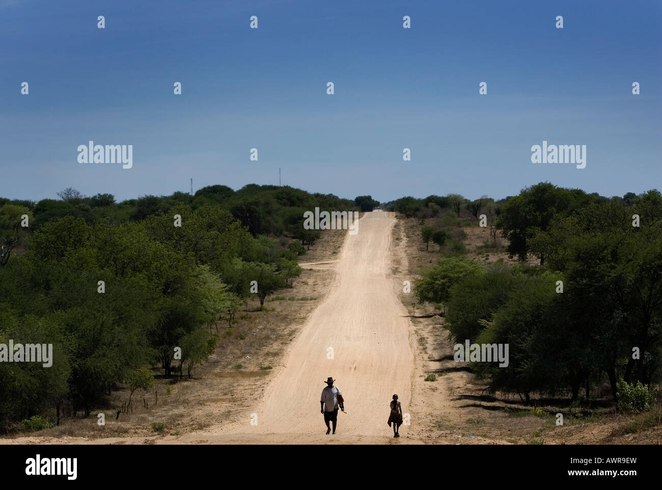 People walk along the Ngonga road in the direction of Ngonga in the ...