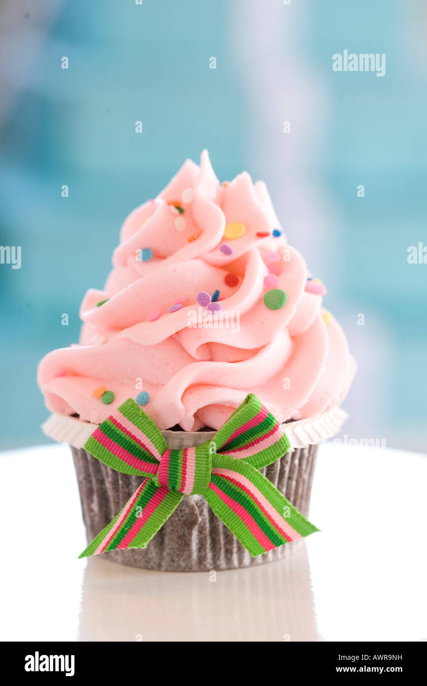 Cupcake with pink icing Stock Photo - Alamy