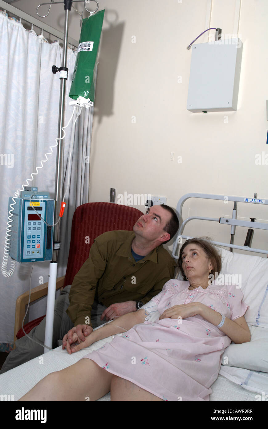 Patient and partner (husband) comforting each other whilst patient is ...
