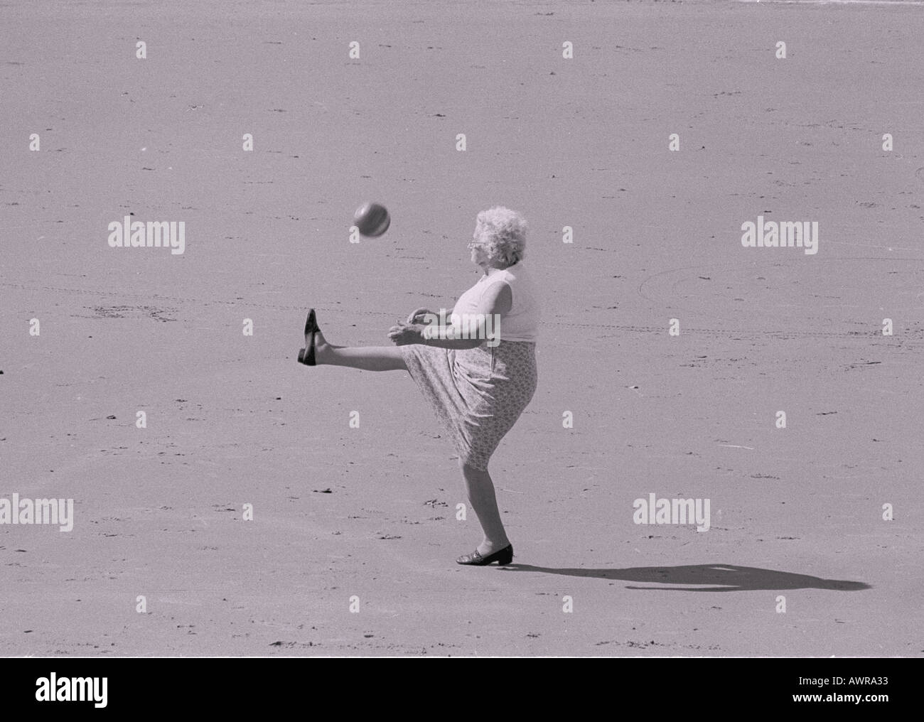 Elderly Woman playing Football on Beach Wales Stock Photo - Alamy