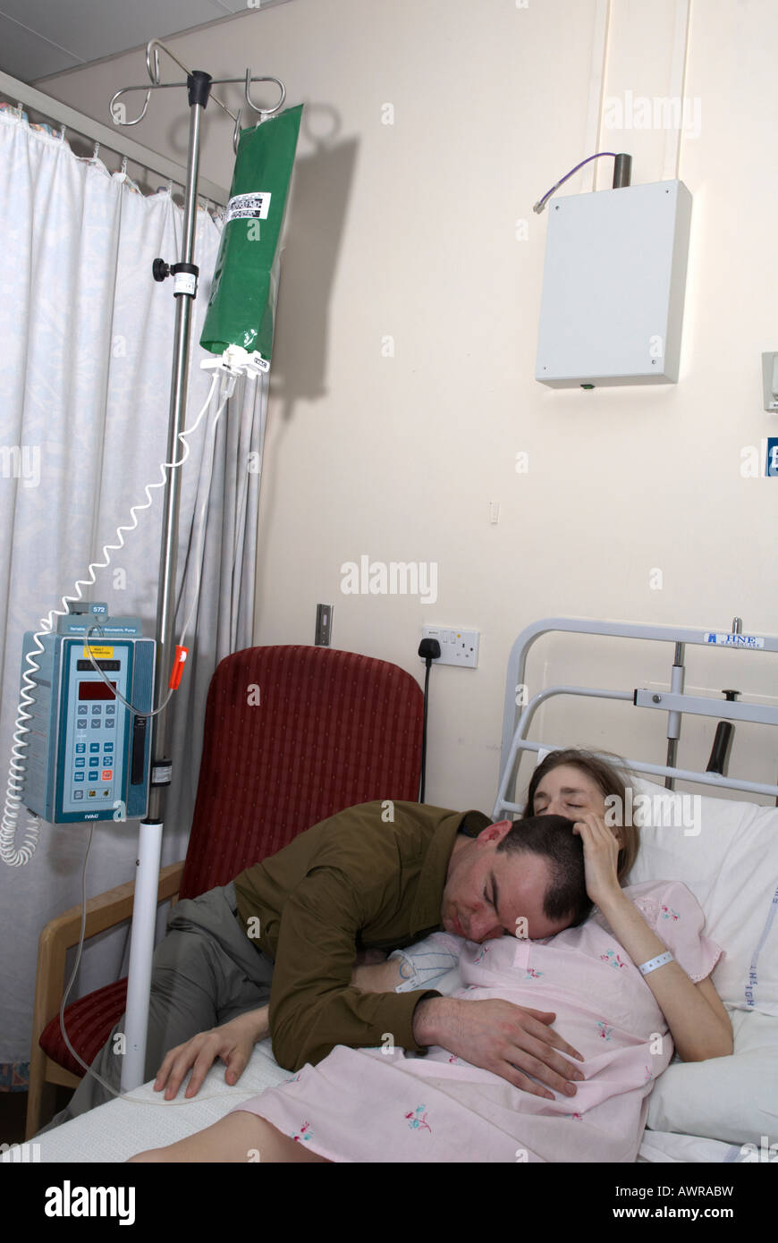 Patient and partner (husband) comforting each other whilst patient is ...