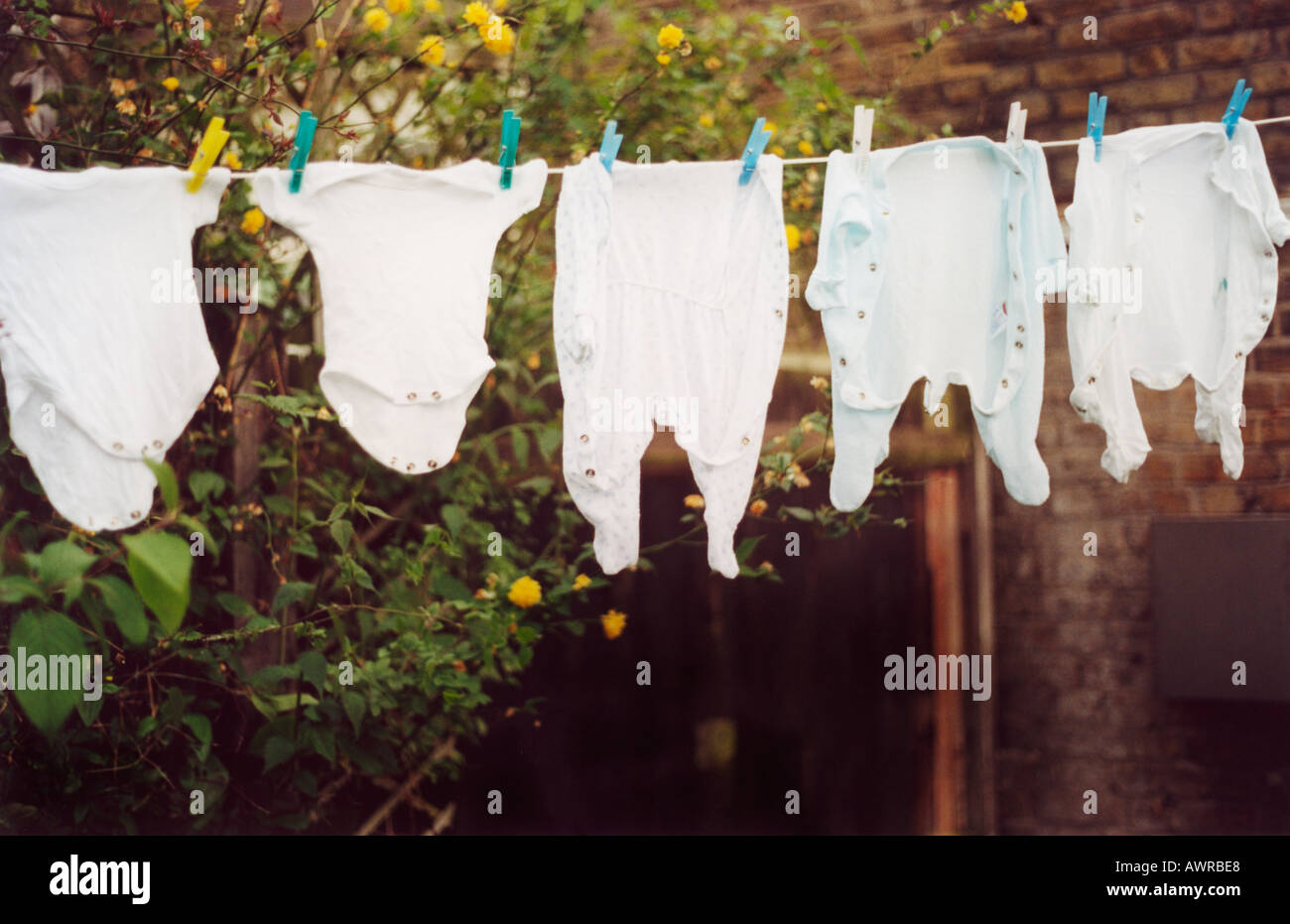 Baby clothes on washing line Stock Photo - Alamy