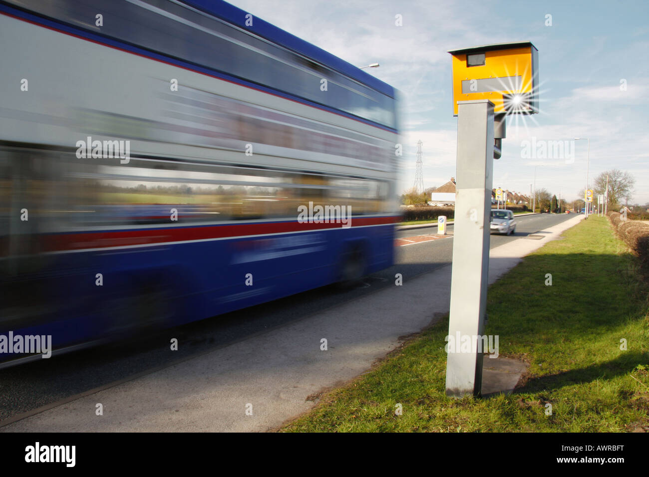 A bus zooming past a Gatso speed camera while the flash appears to be ...
