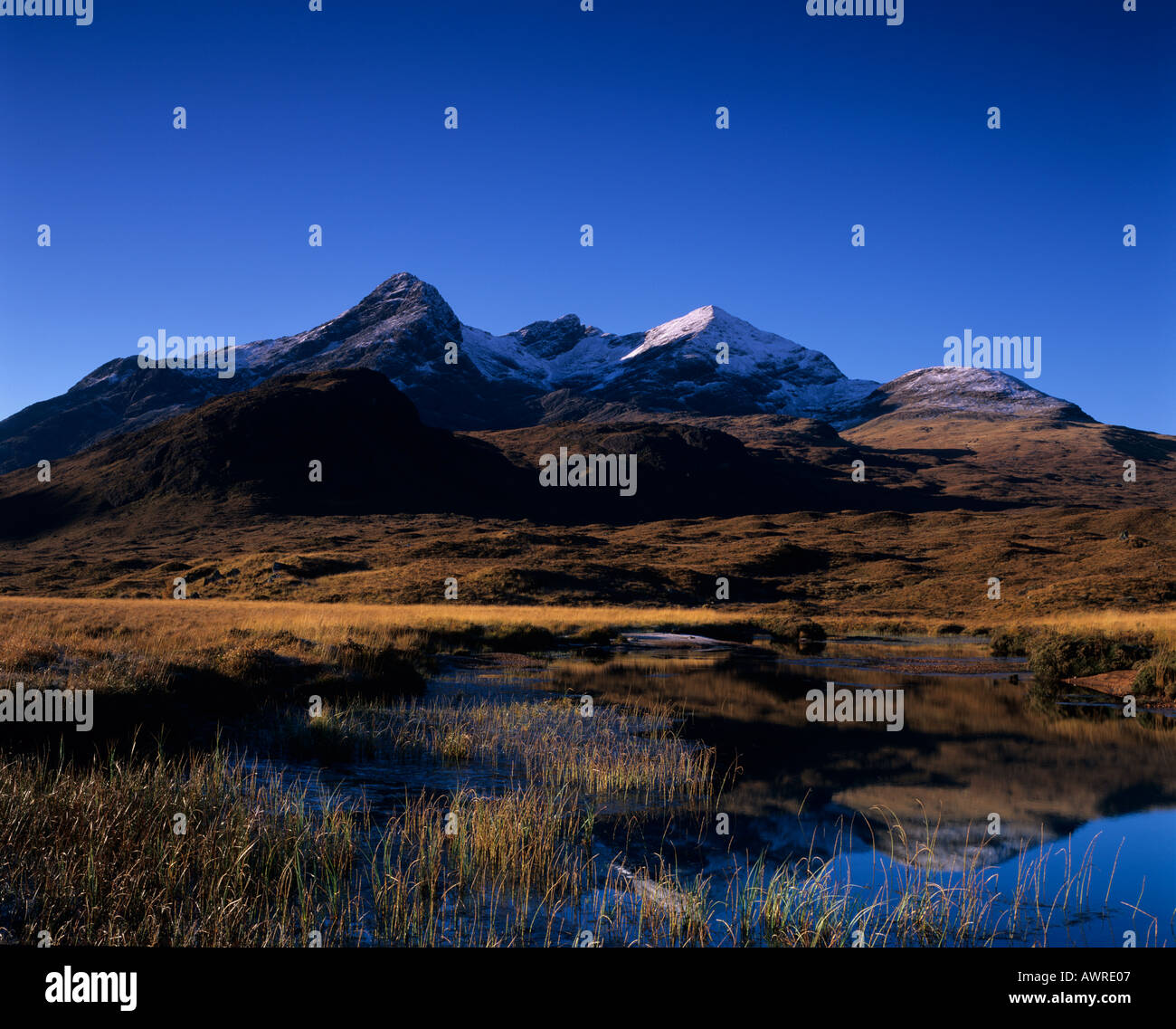Snow topped Cuillin Hills reflected in the River Slighachan Glen ...
