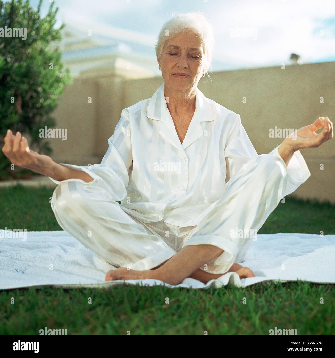Mature woman in lotus position, outside Stock Photo - Alamy