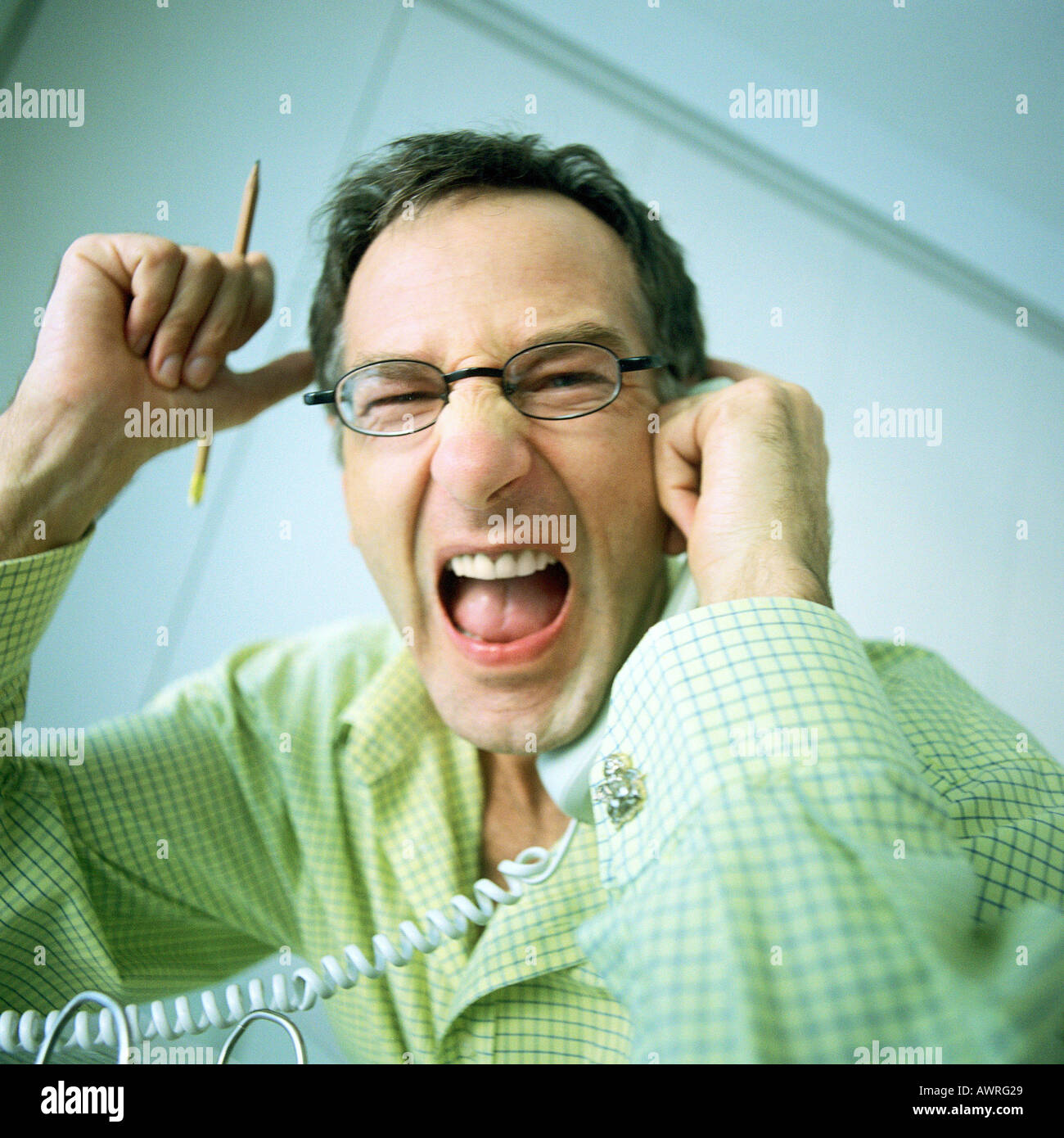 Man holding phone, shouting, portrait Stock Photo - Alamy