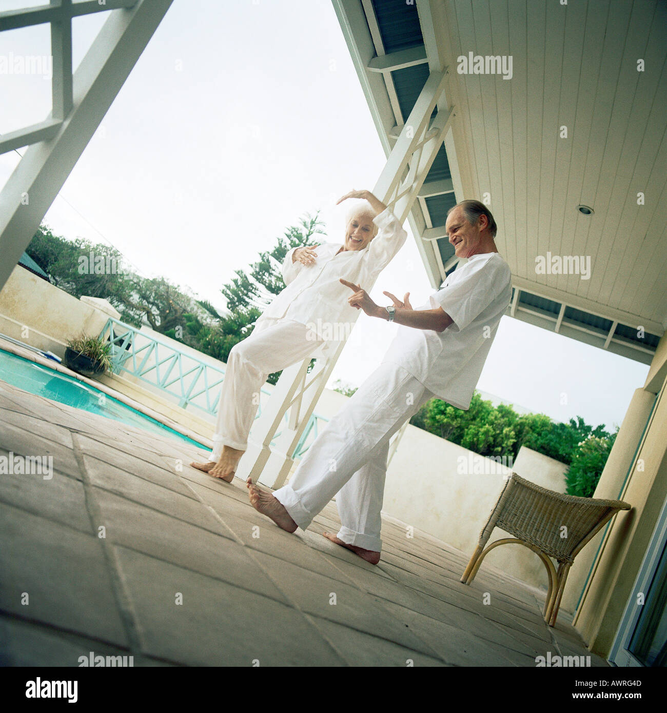 Senior couple dancing near swimming pool Stock Photo - Alamy