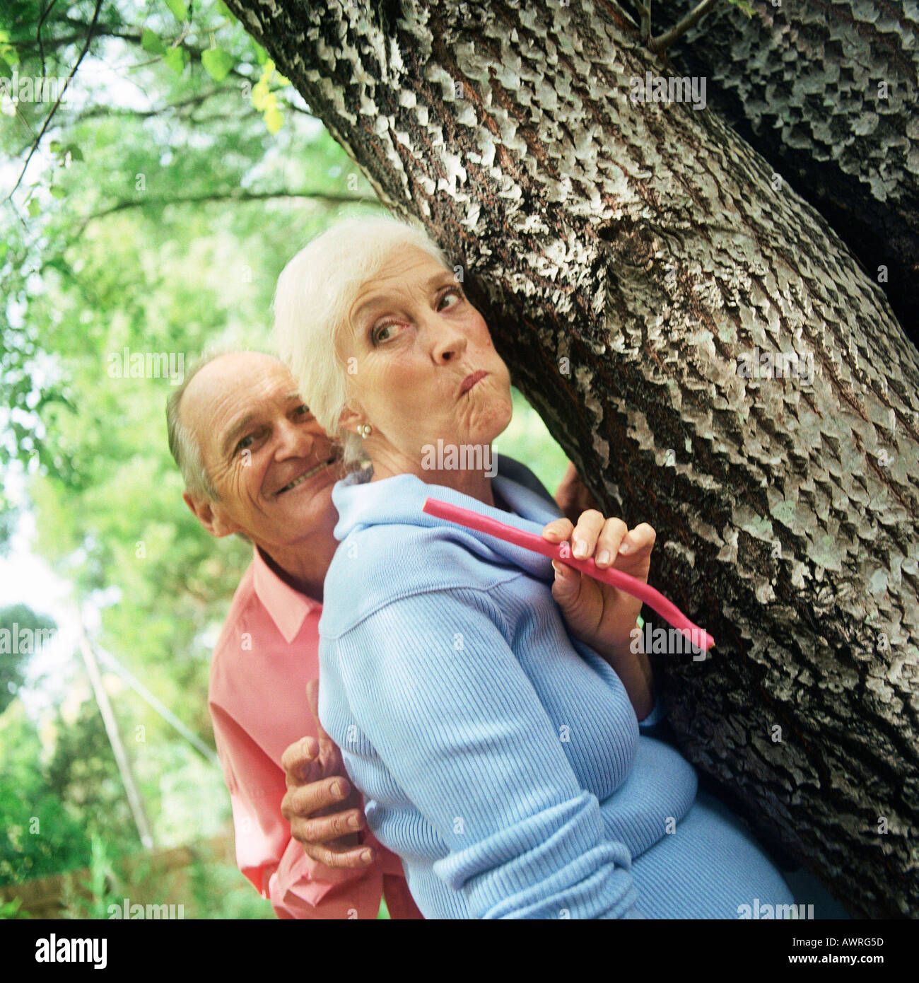 Friends hiding behind tree in hi-res stock photography and images - Alamy