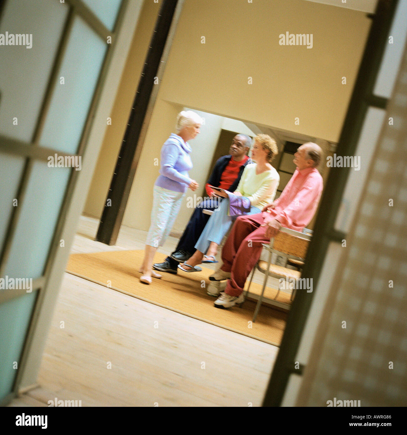 Four people standing in room Stock Photo - Alamy Four people standing in room Stock Photo - Alamy