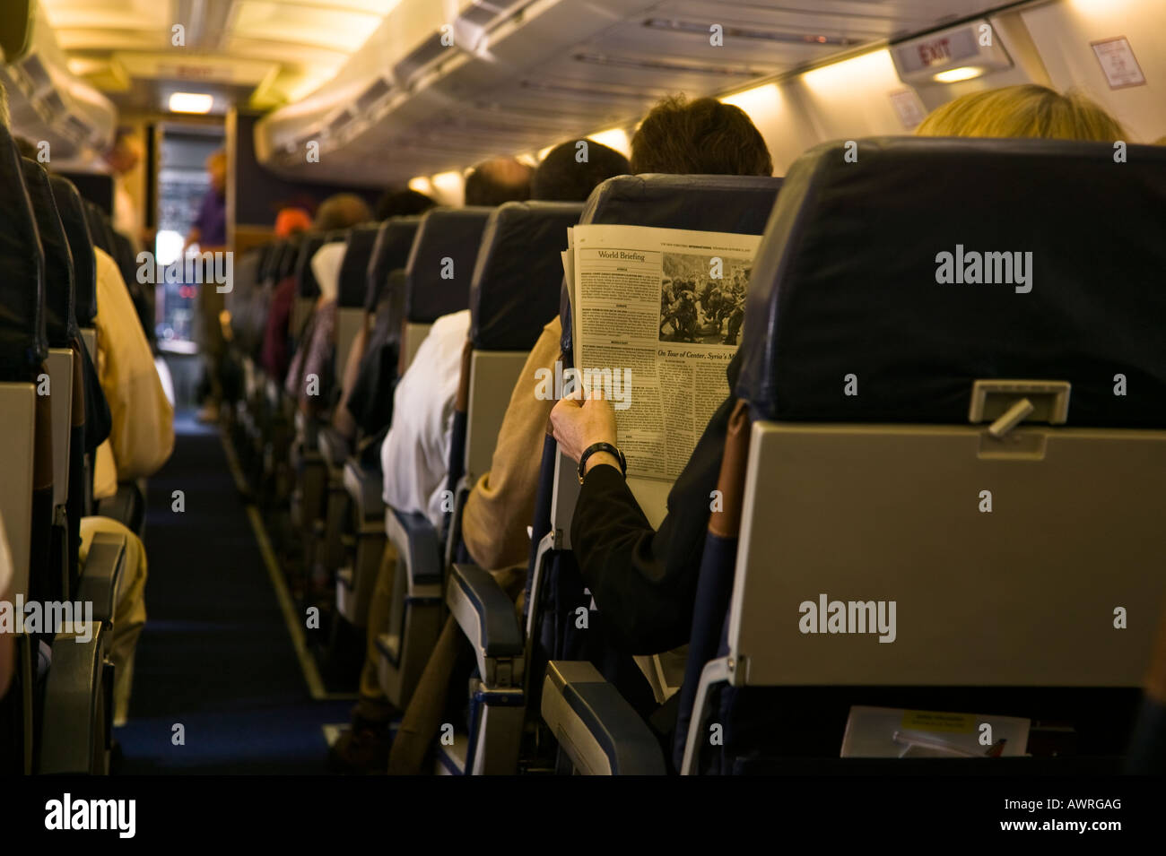 Aircraft aisle and passangers Stock Photo - Alamy