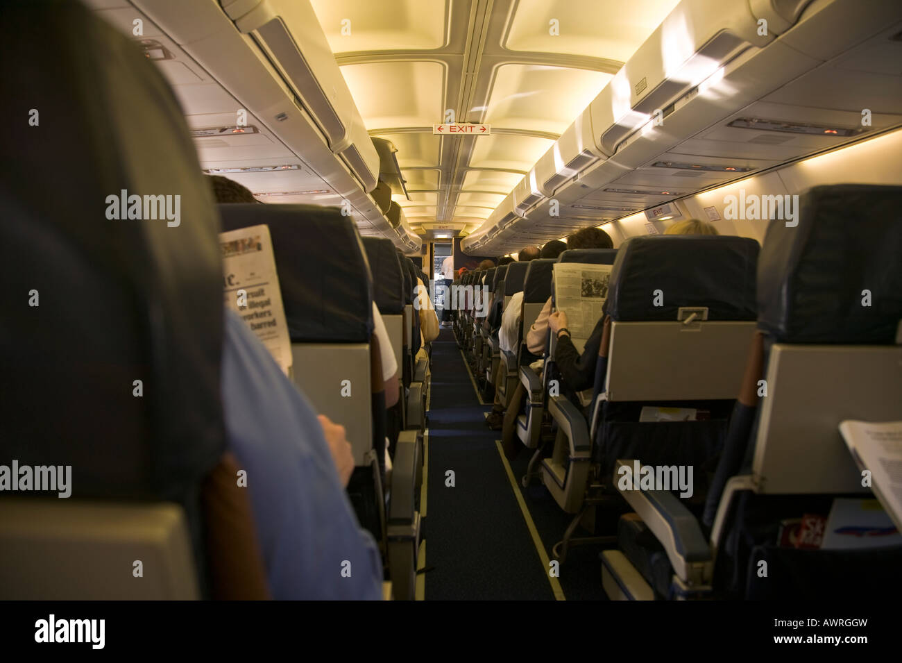 Aircraft aisle and passangers Stock Photo - Alamy