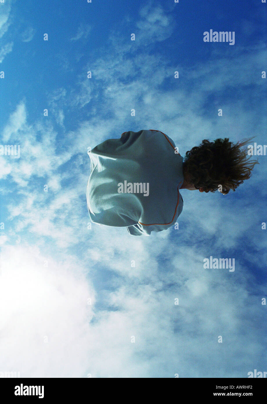 Young man in mid-air, low angle, rear view Stock Photo - Alamy