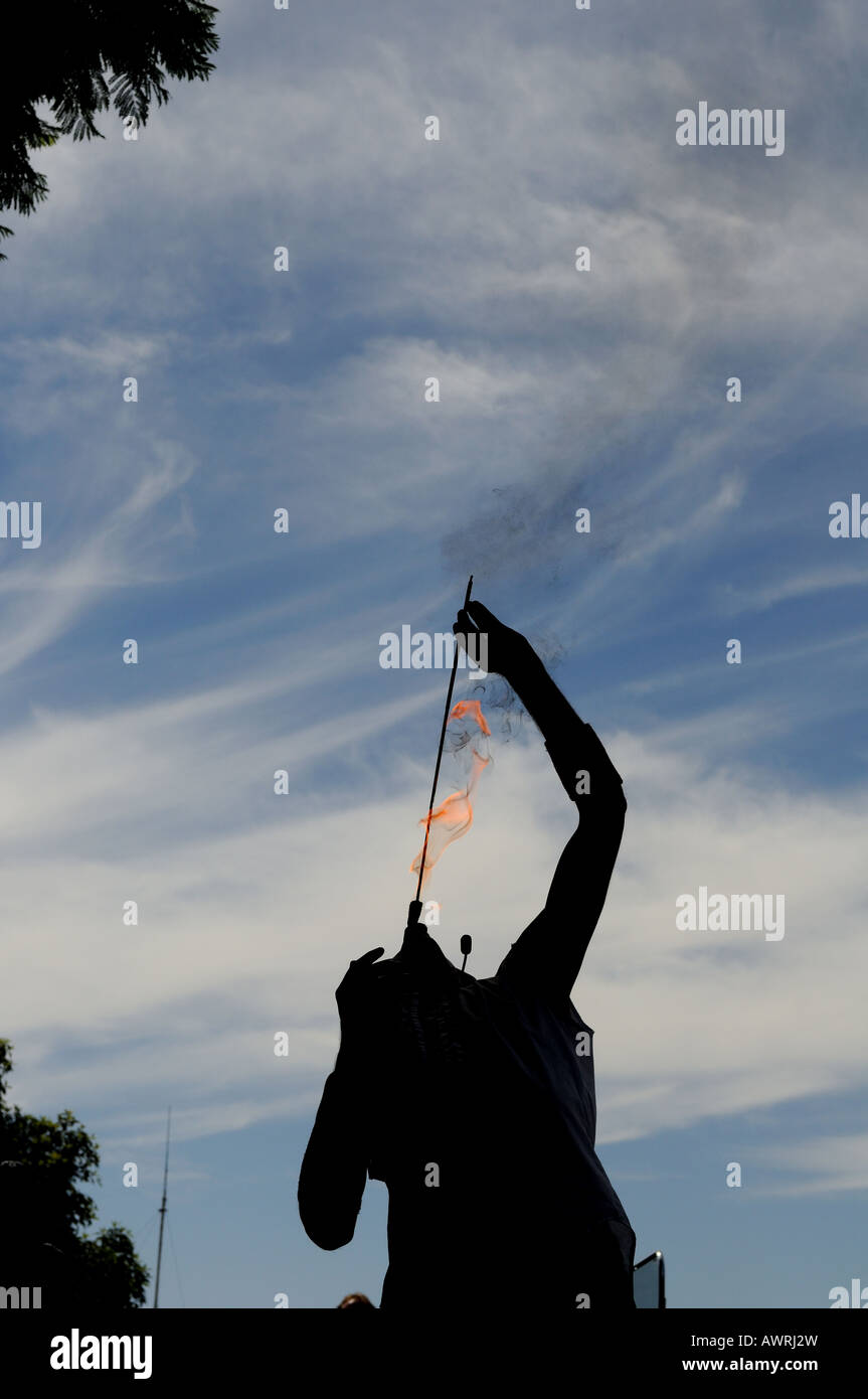 A street performer eating fire Stock Photo - Alamy