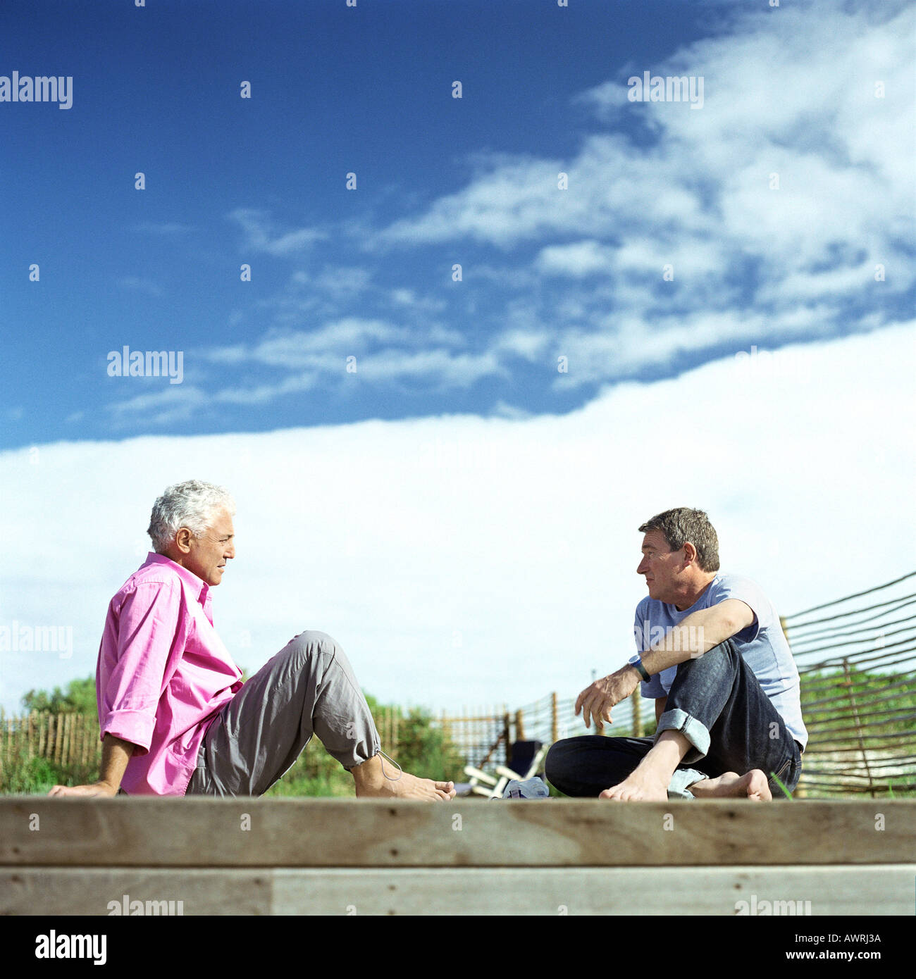 Two mature men sitting face to face Stock Photo - Alamy