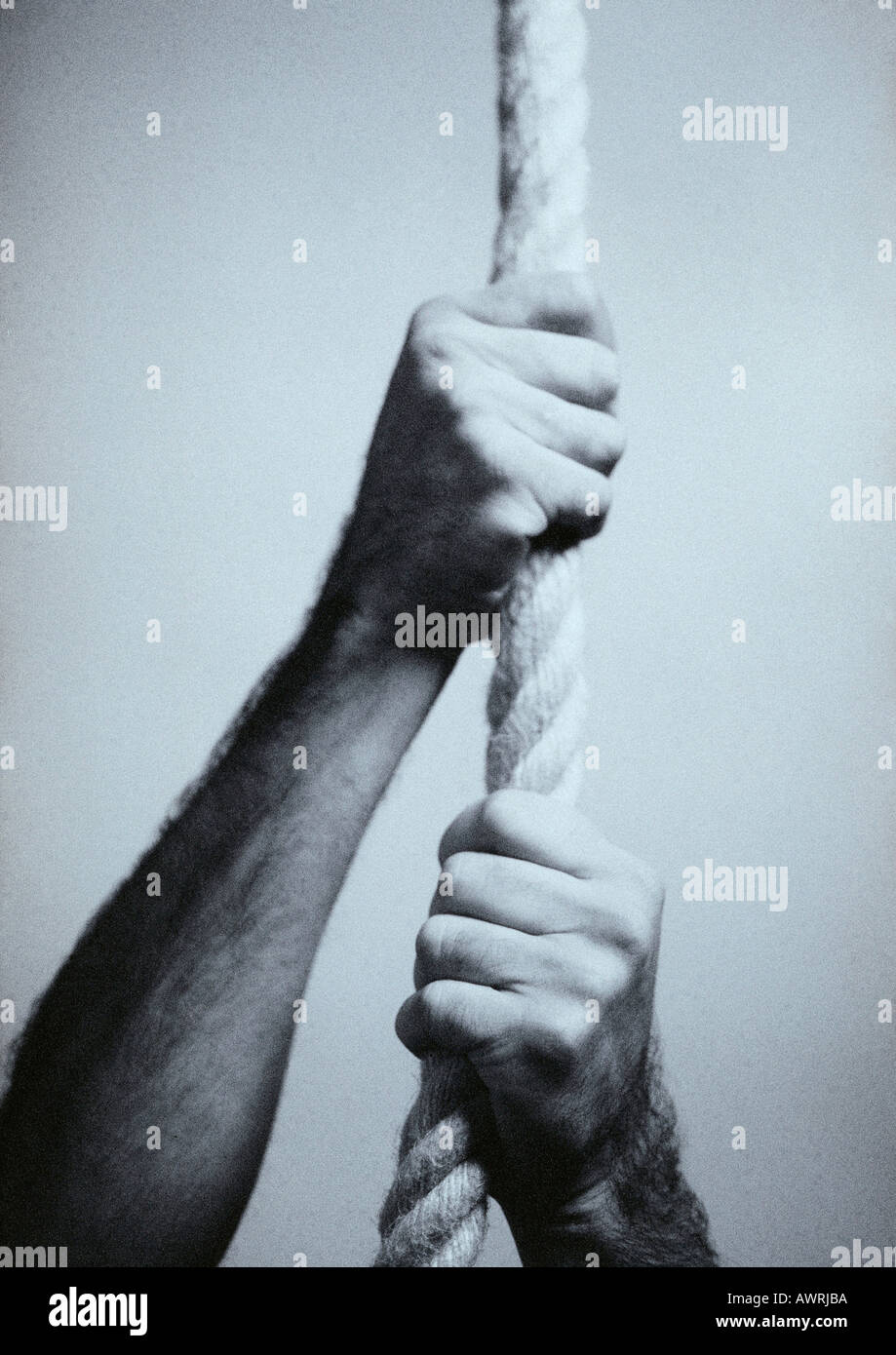 Man pulling rope, cropped view of hands Stock Photo - Alamy