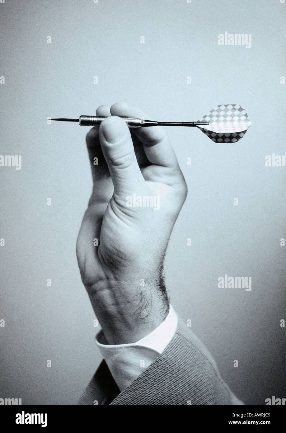 Hand holding dart, close-up Stock Photo - Alamy