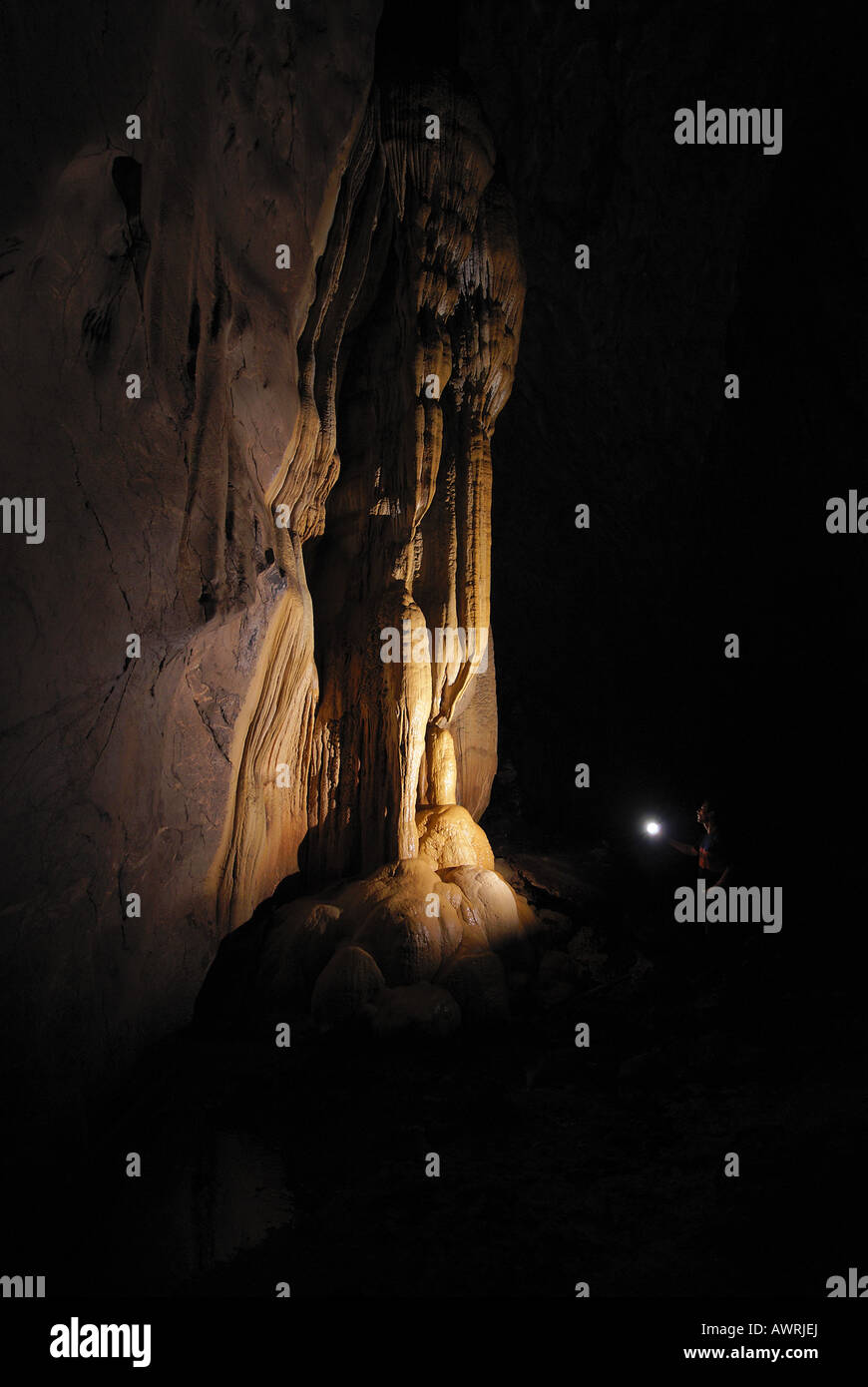 A caver admiring an enormous calcite flowstone deposit Stock Photo - Alamy