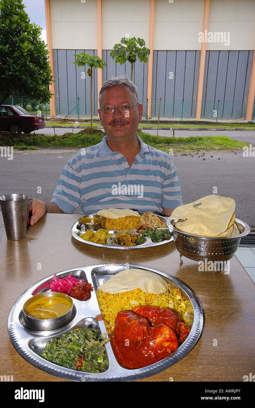 A man with two curries Stock Photo - Alamy