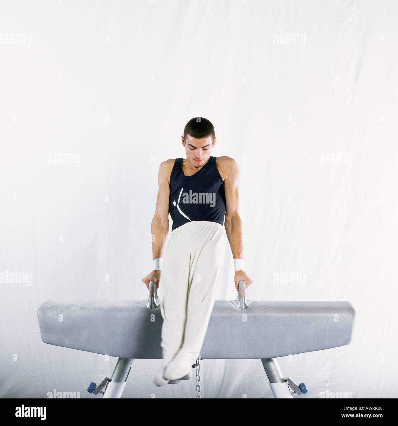 Young male gymnast performing routine on pommel horse Stock Photo - Alamy
