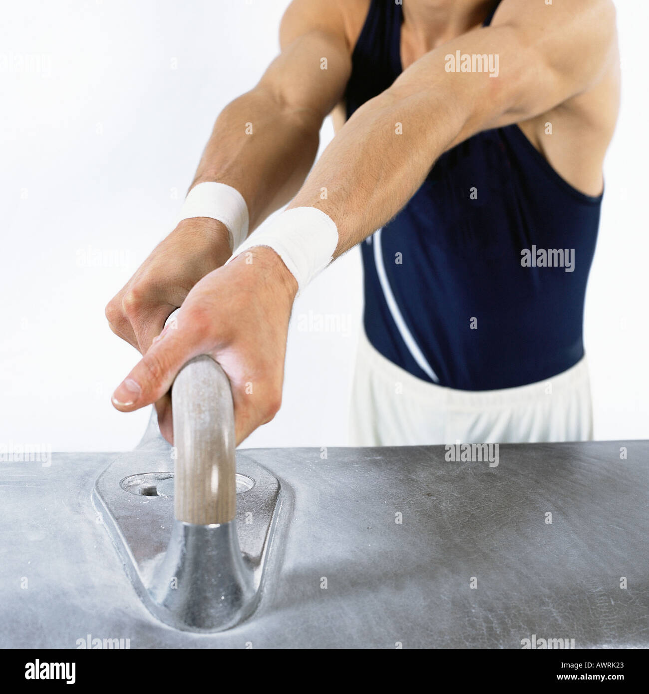 Male gymnast gripping handle on pommel horse, mid section Stock Photo ...