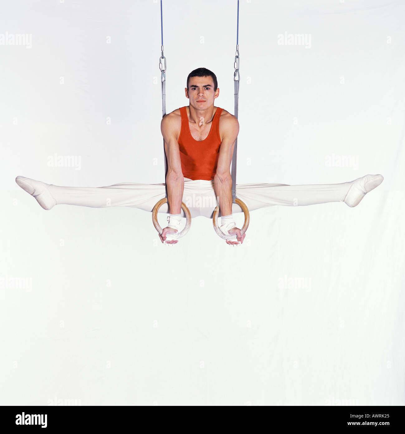 Male gymnast performing on rings hi-res stock photography and images ...