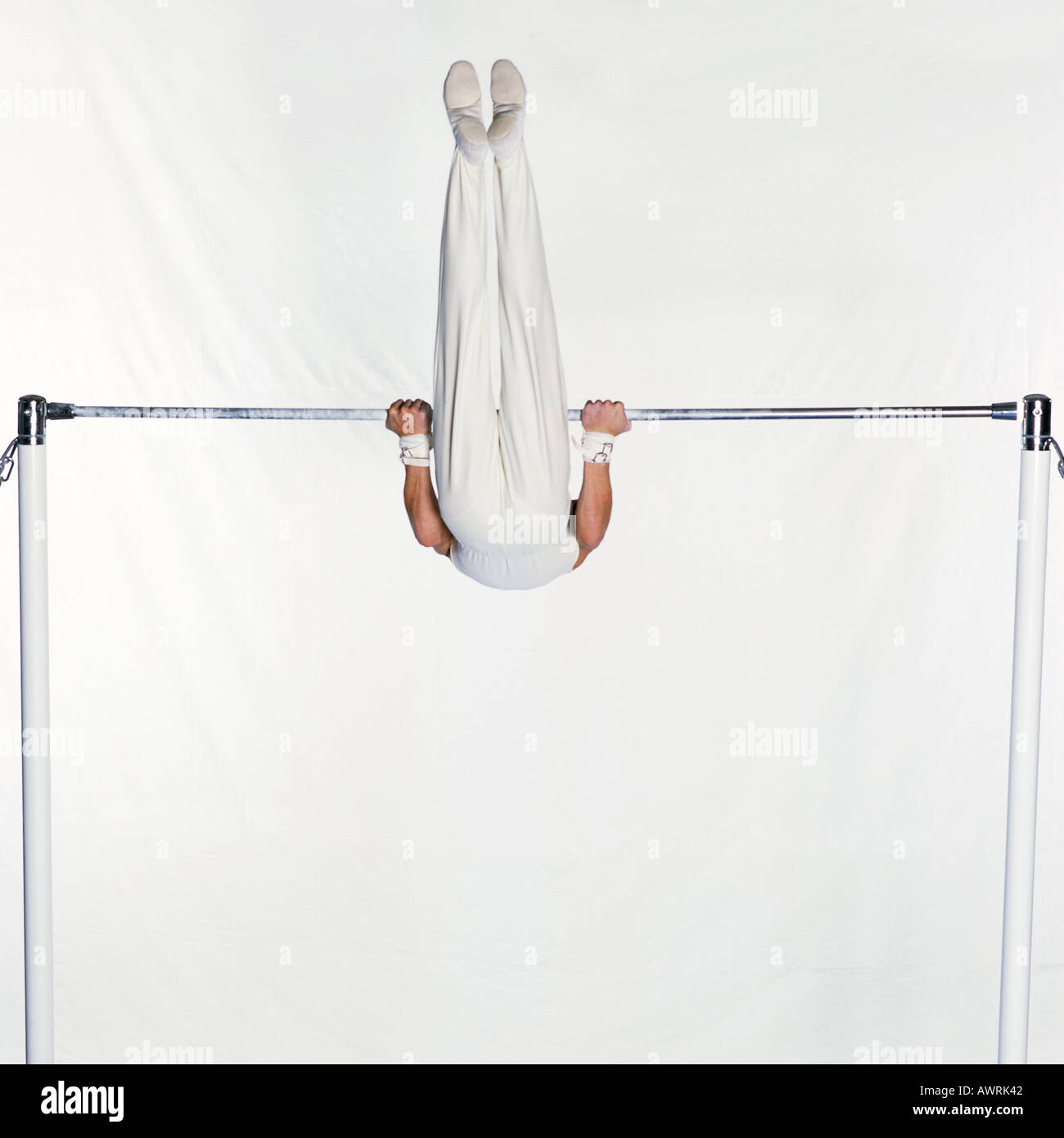 Male gymnast swinging on horizontal bar Stock Photo - Alamy