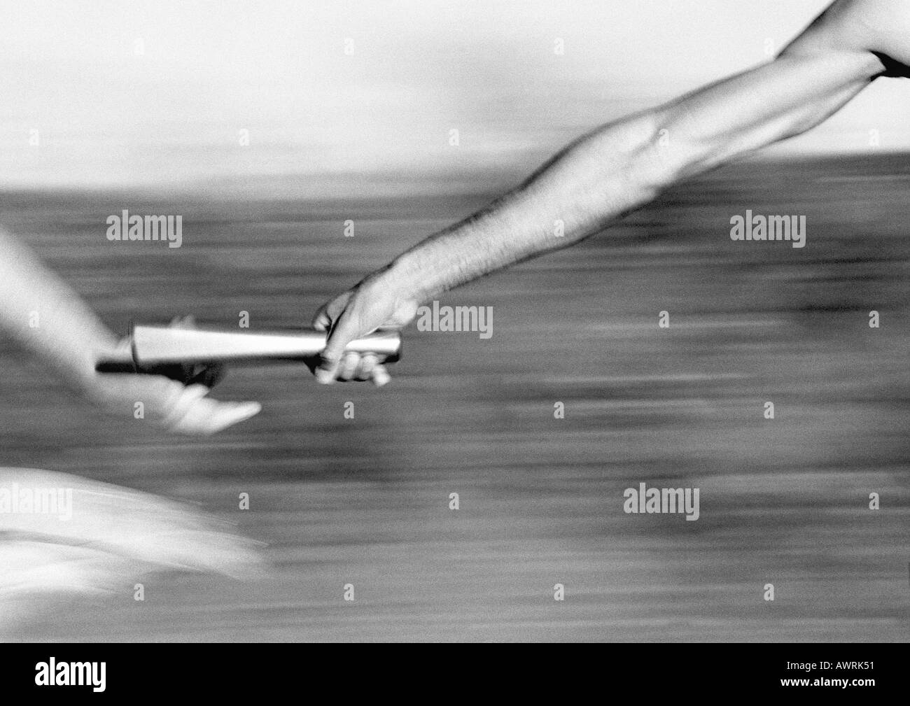 Male athletes passing relay baton, close-up, b&w Stock Photo - Alamy