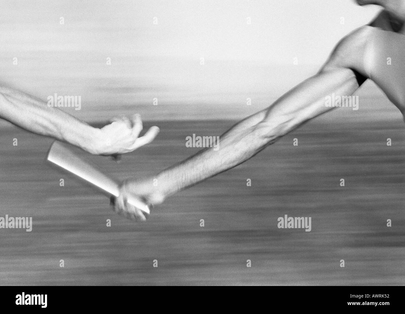 Male athletes passing relay baton, close-up, b&w Stock Photo - Alamy
