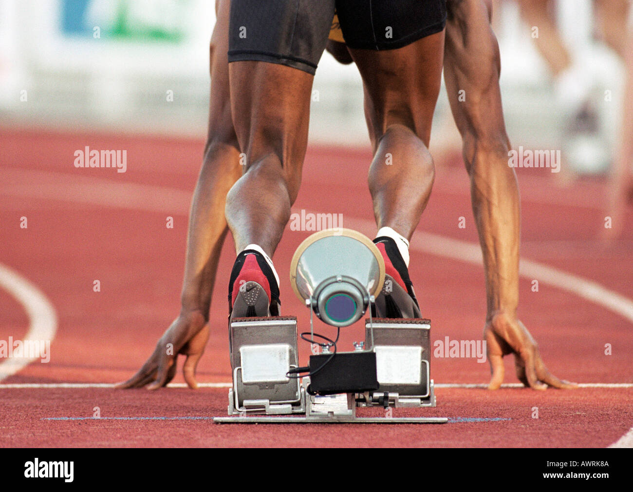 Male runner on starting block, low section, rear view Stock Photo - Alamy