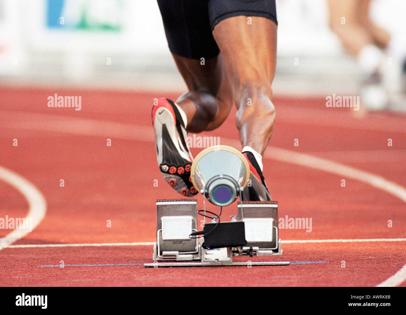 Male runner leaving starting block, low section Stock Photo - Alamy