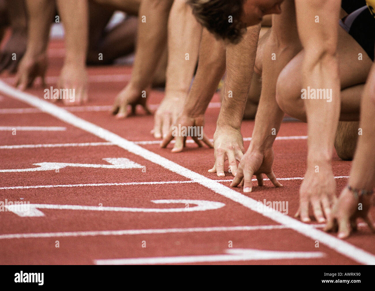 Male runners at starting line, low section, close-up Stock Photo - Alamy