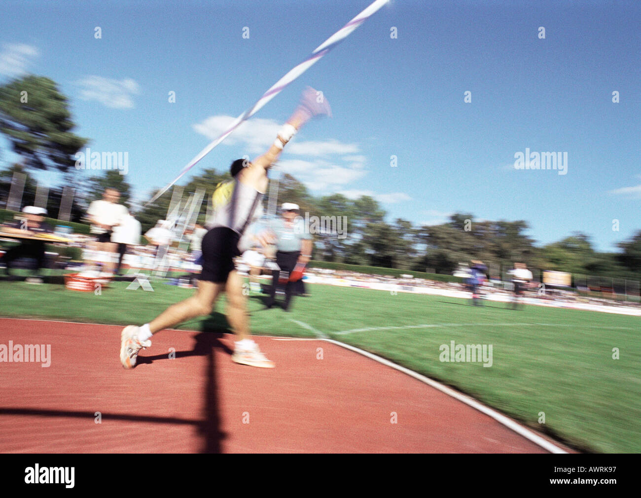 Male athlete throwing javelin, blurred motion Stock Photo - Alamy