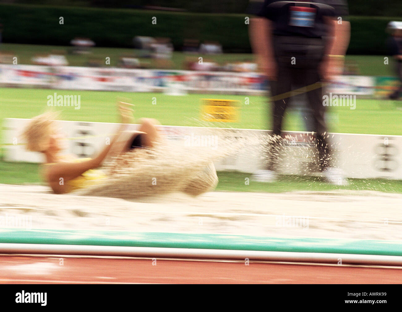 Female long jumper landing in sand pit, blurred motion Stock Photo - Alamy