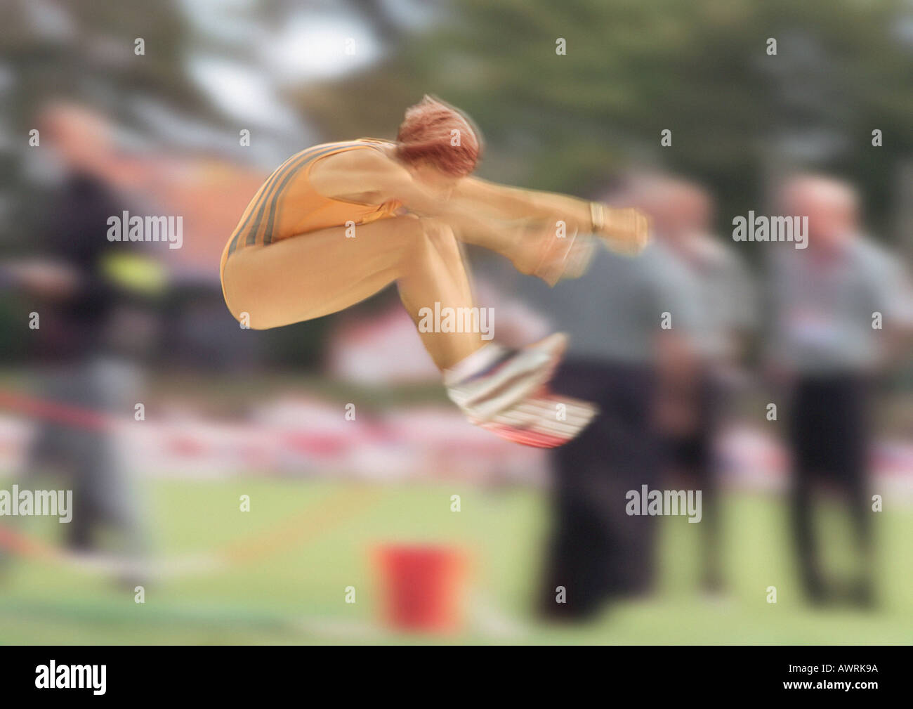 Female long jumper in mid-air, blurred motion Stock Photo - Alamy