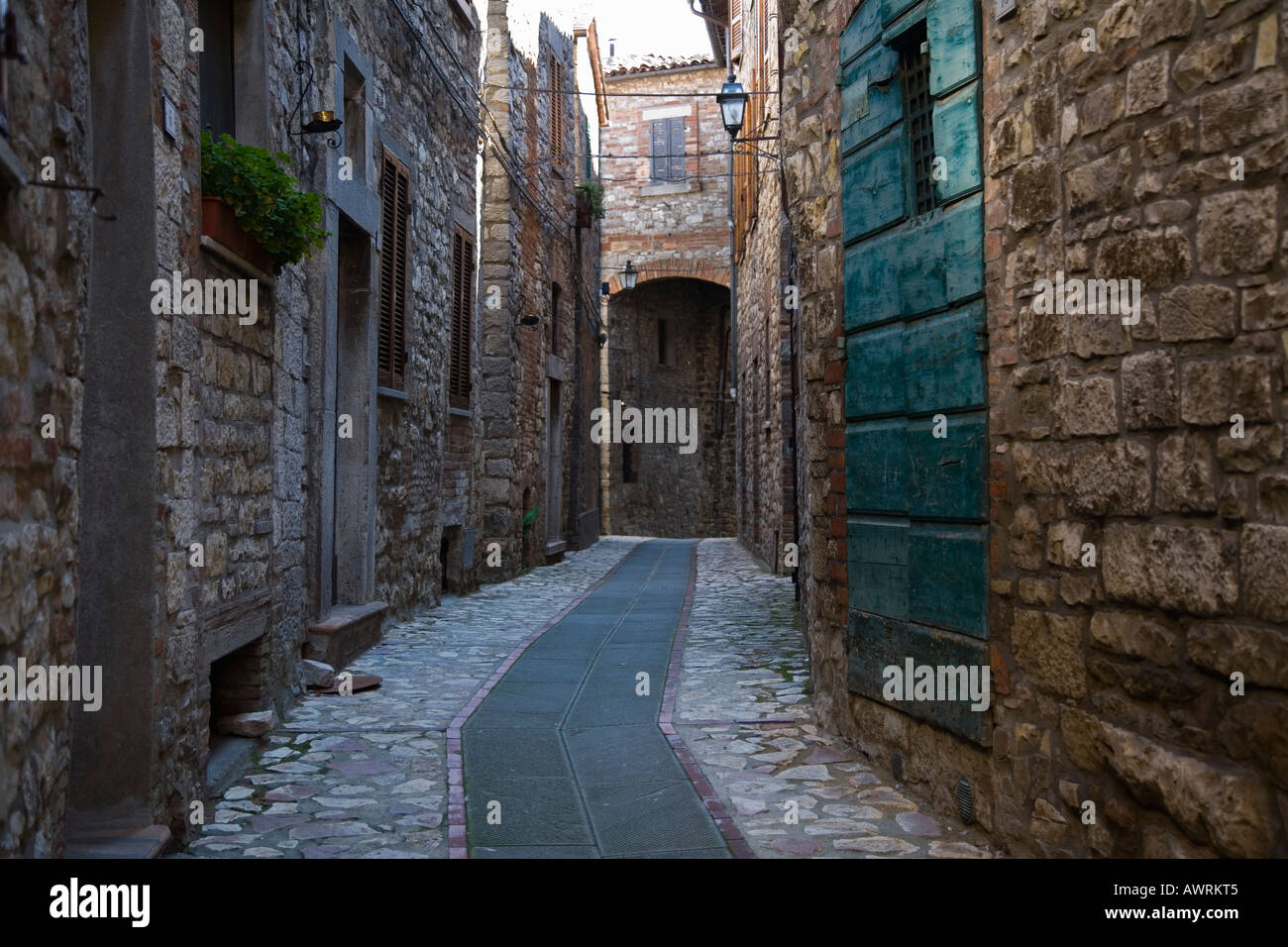 Narrow passageway between stone walls in the medieval hilltown village ...
