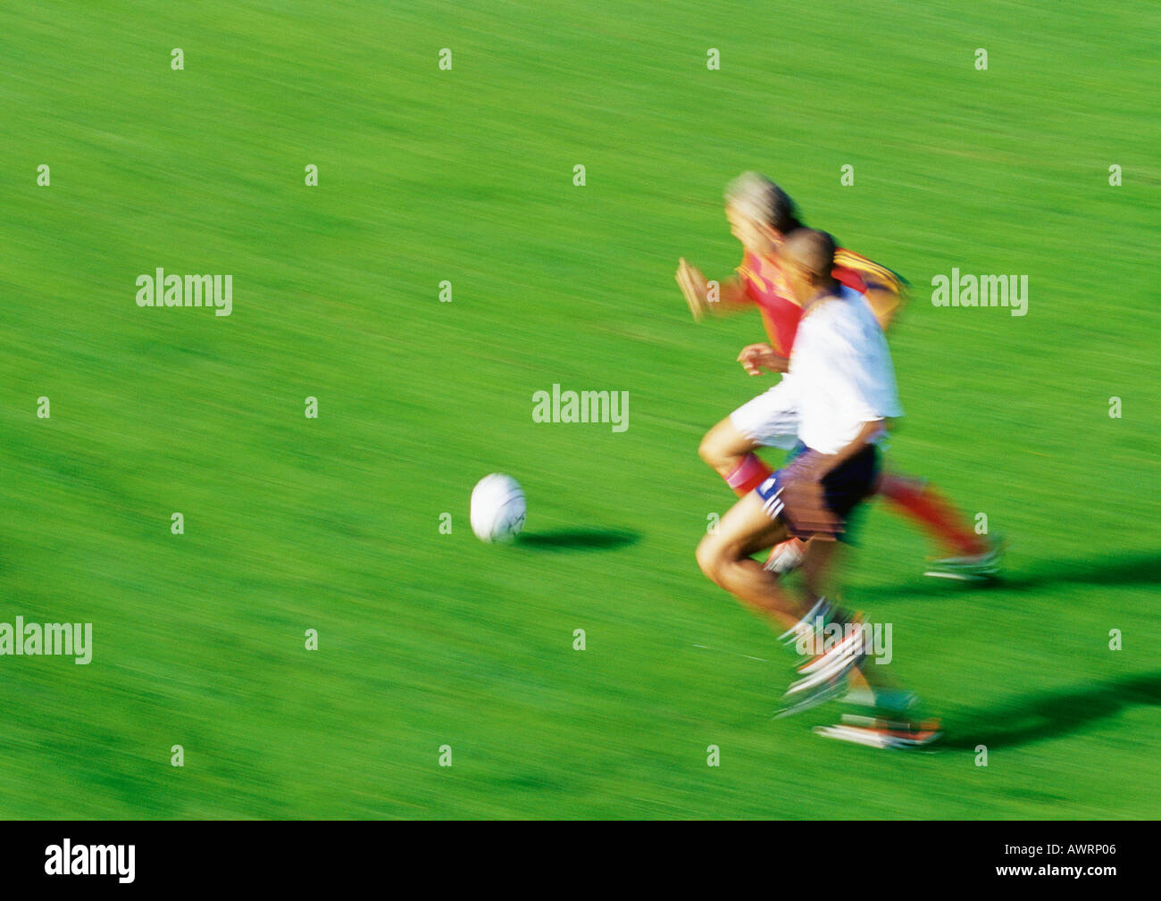 Two soccer players running for ball Stock Photo - Alamy